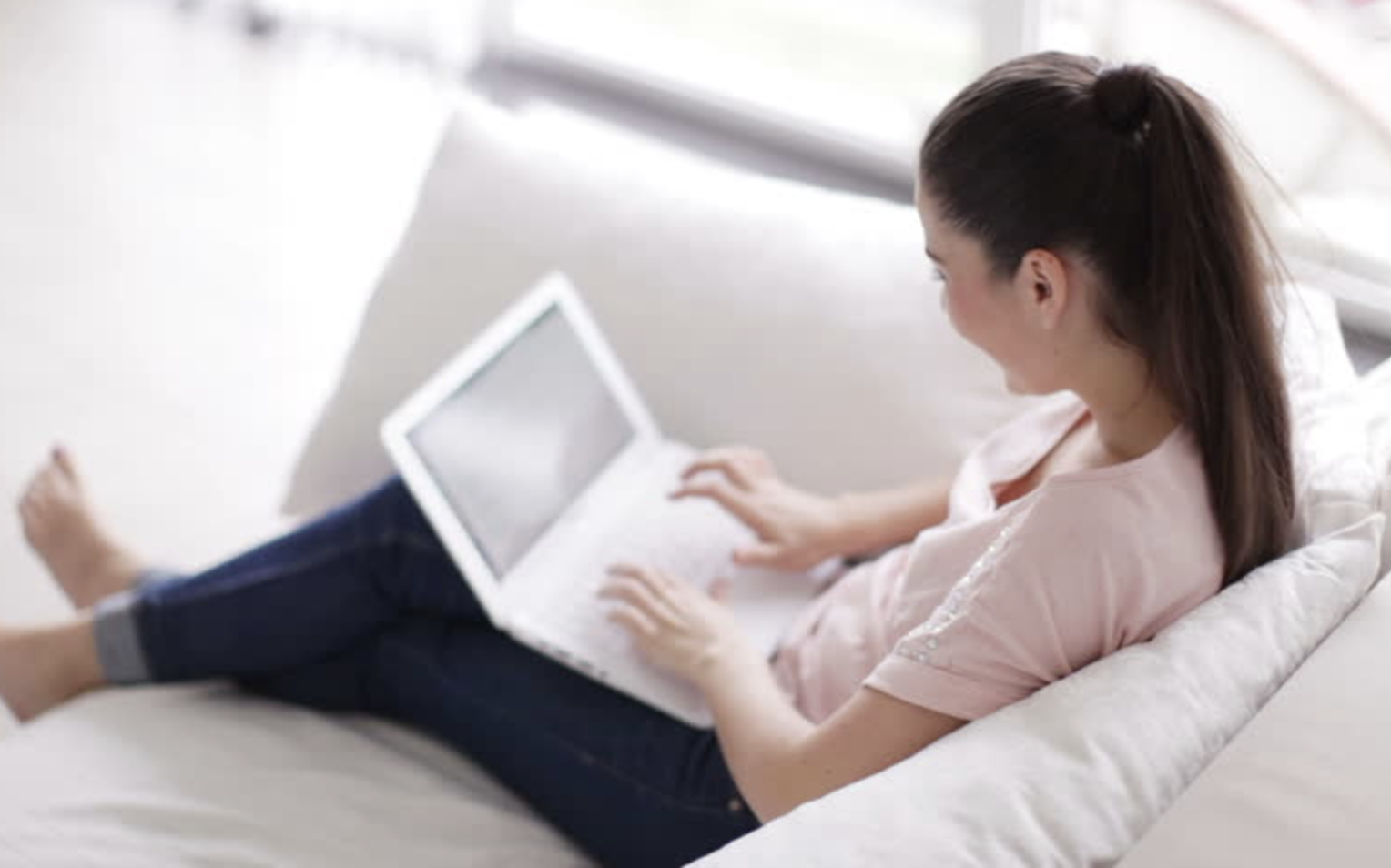 girl typing on her computer