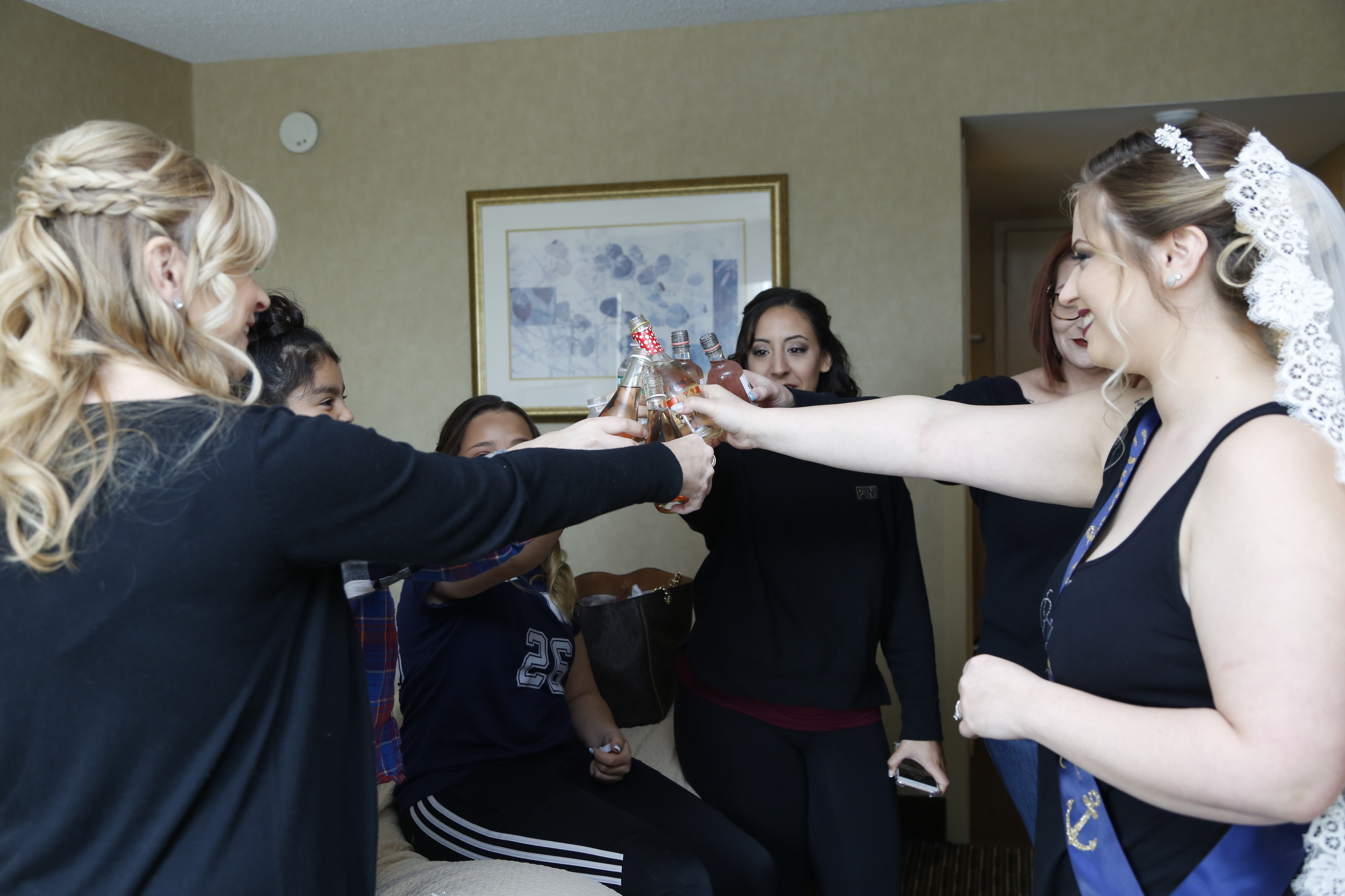 bride and bridesmaids toasting